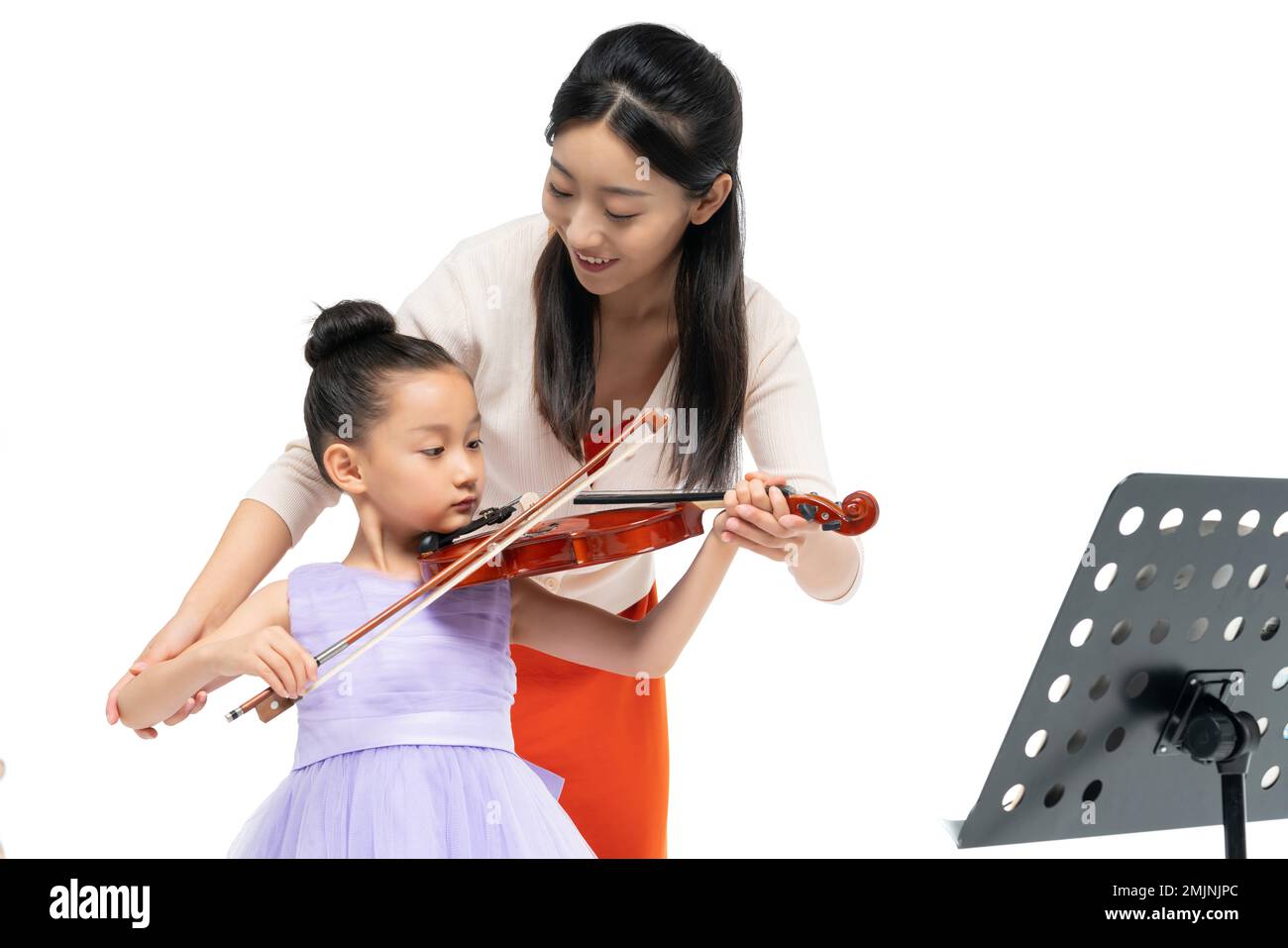 The female teacher guide girl playing Musical Instruments Stock Photo ...