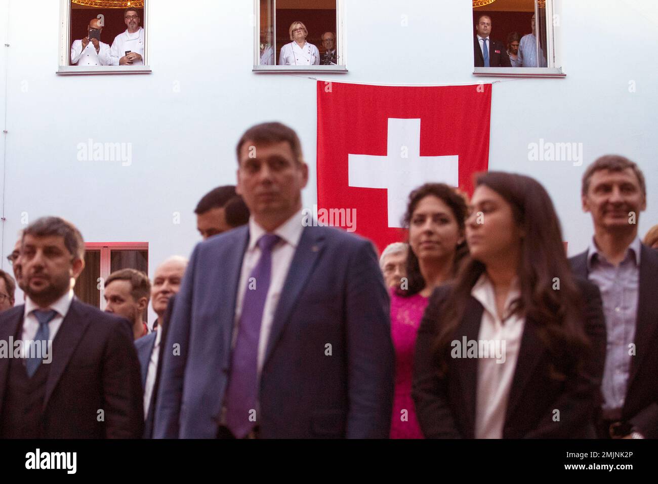 Employees, background top, watch from the windows the opening ceremony ...