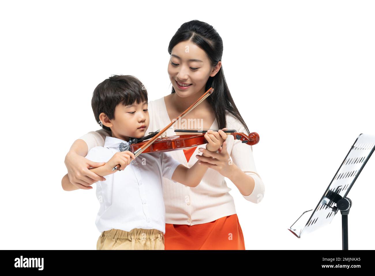 The female teacher guide the boy playing Musical Instruments Stock ...