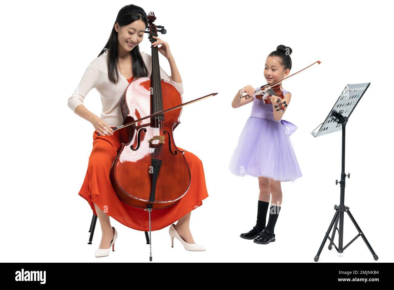 The female teacher guide girl playing Musical Instruments Stock Photo ...