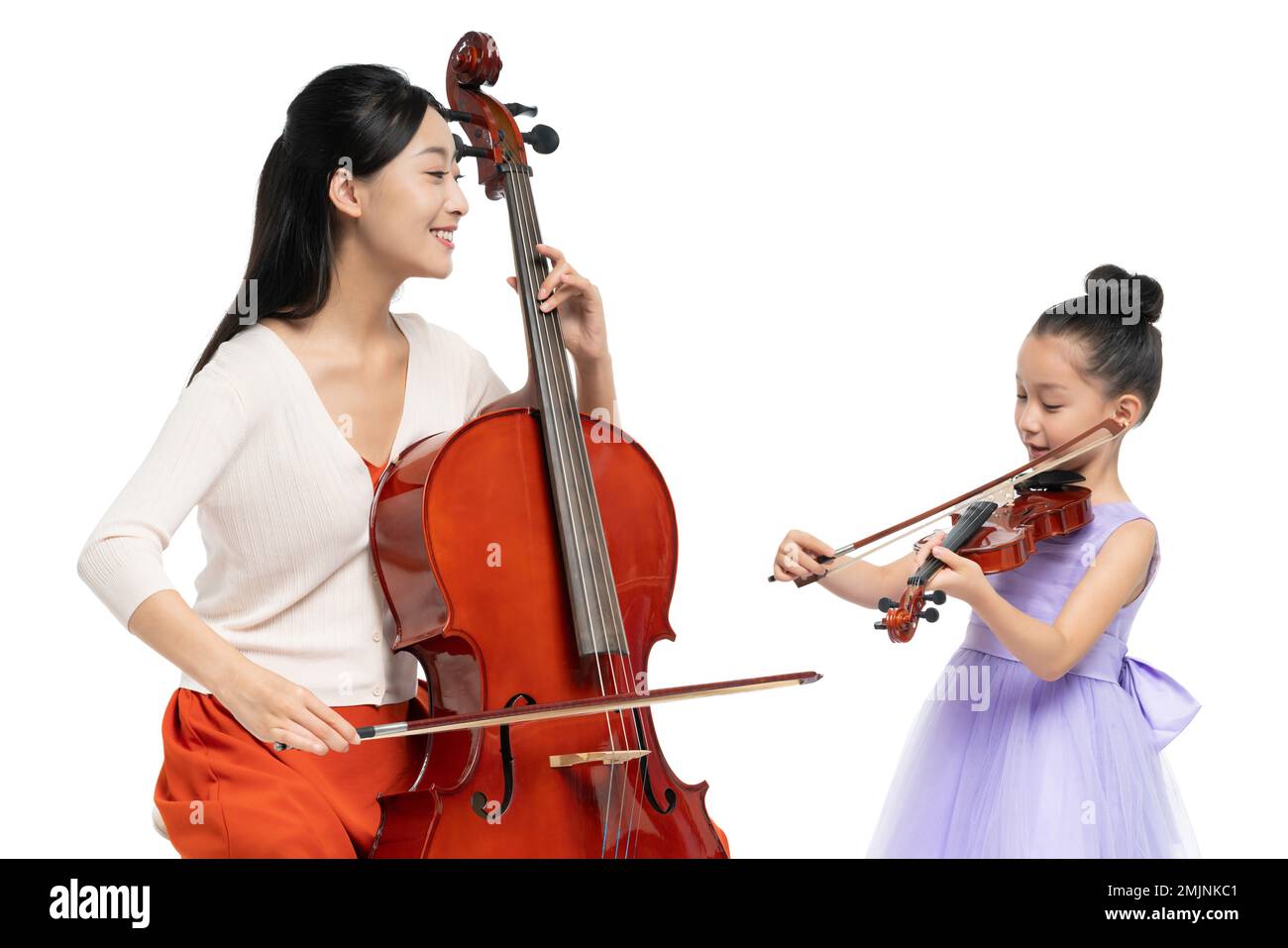 The female teacher guide girl playing Musical Instruments Stock Photo ...