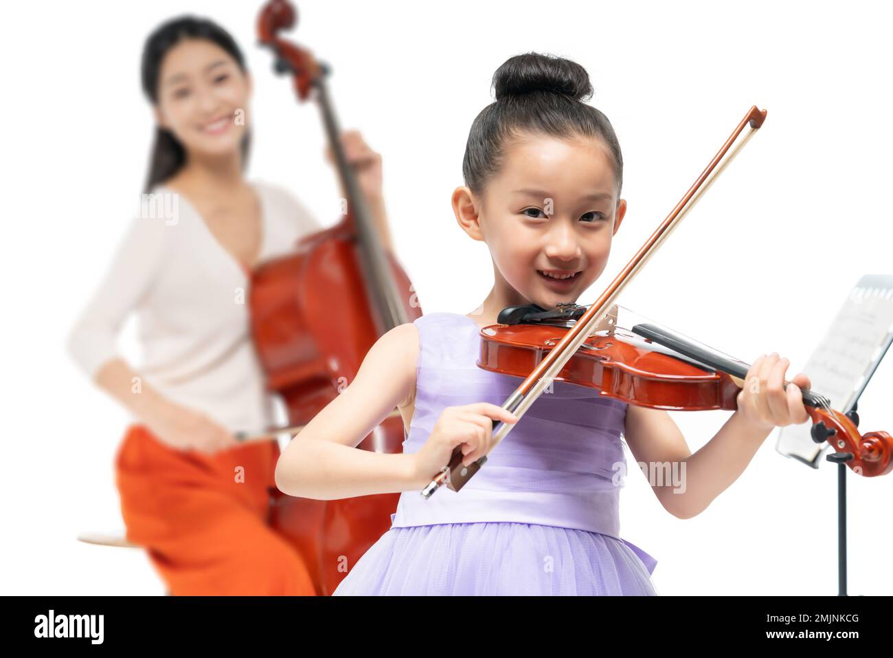 The female teacher guide girl playing Musical Instruments Stock Photo ...