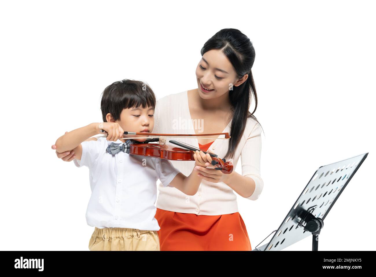 The female teacher guide the boy playing Musical Instruments Stock ...