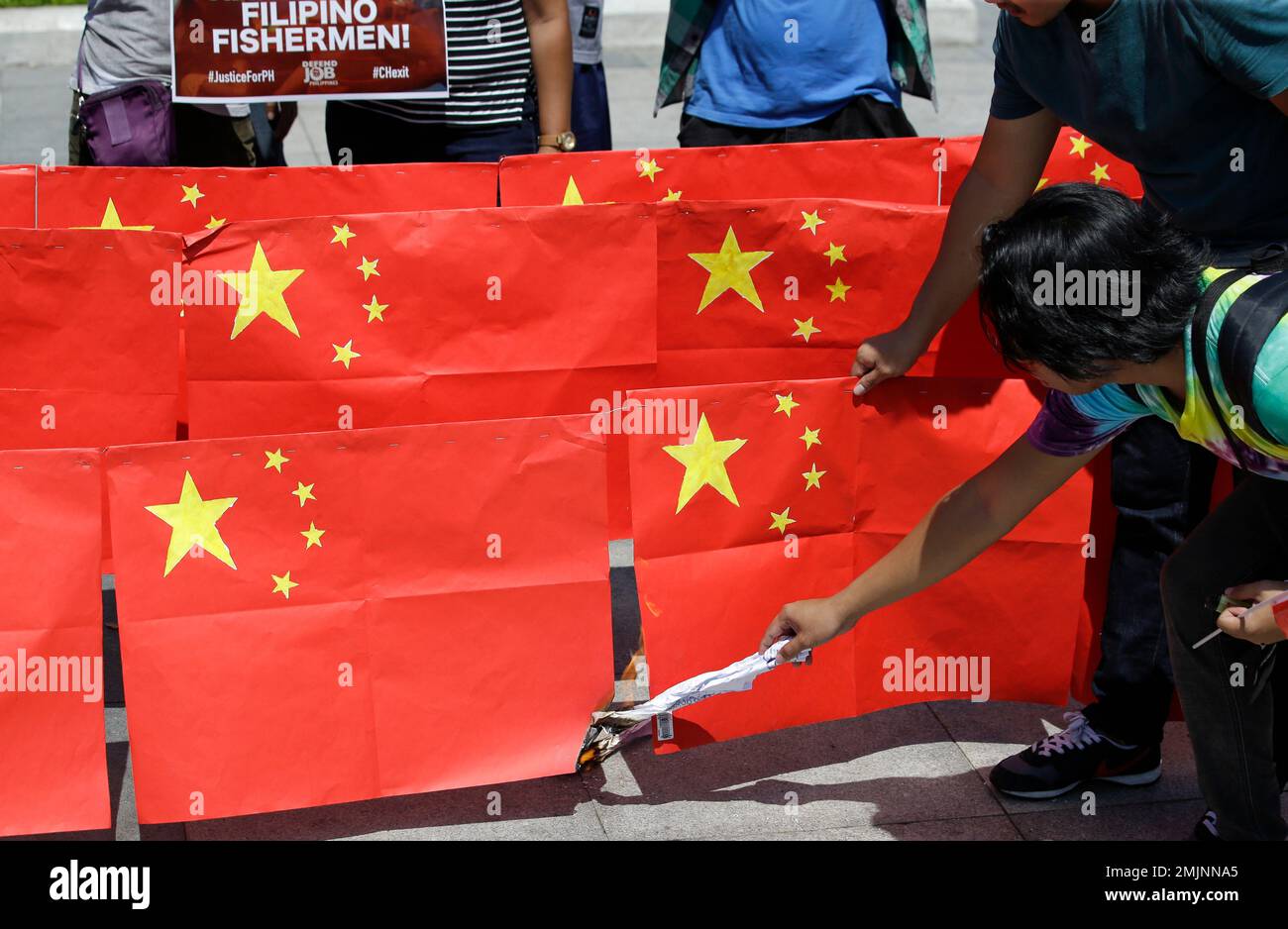 Protesters burn mock Chinese flags at Manila's Rizal park, Philippines ...