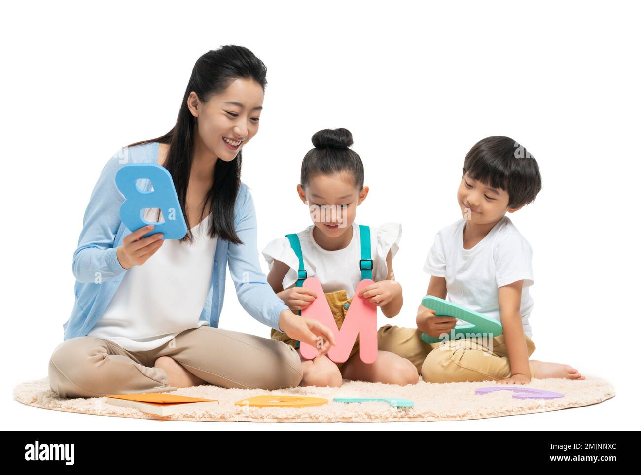 A young female teacher counseling students learning Stock Photo - Alamy