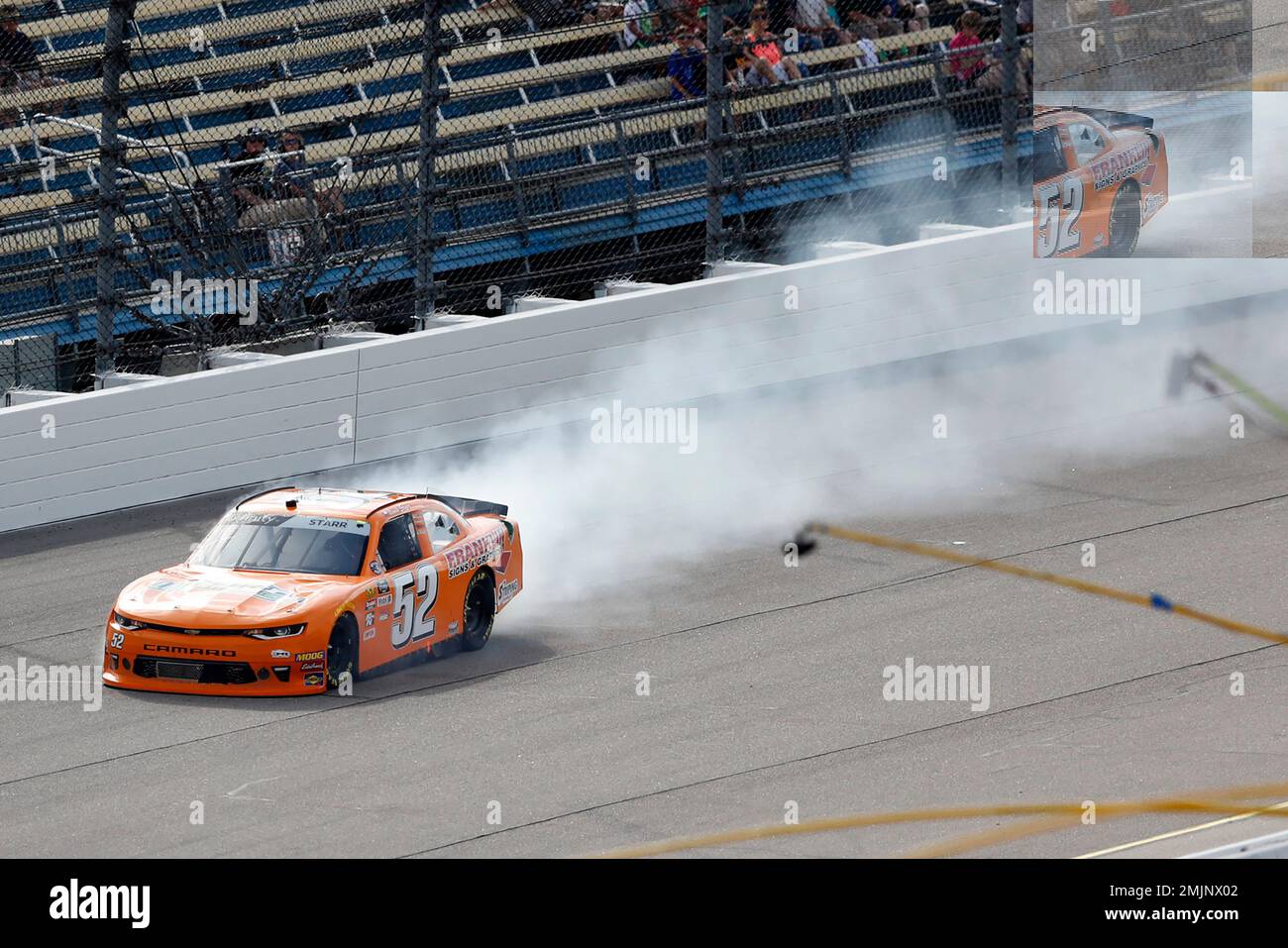 David Starr leaves a trail a smoke as he races his car during a NASCAR ...