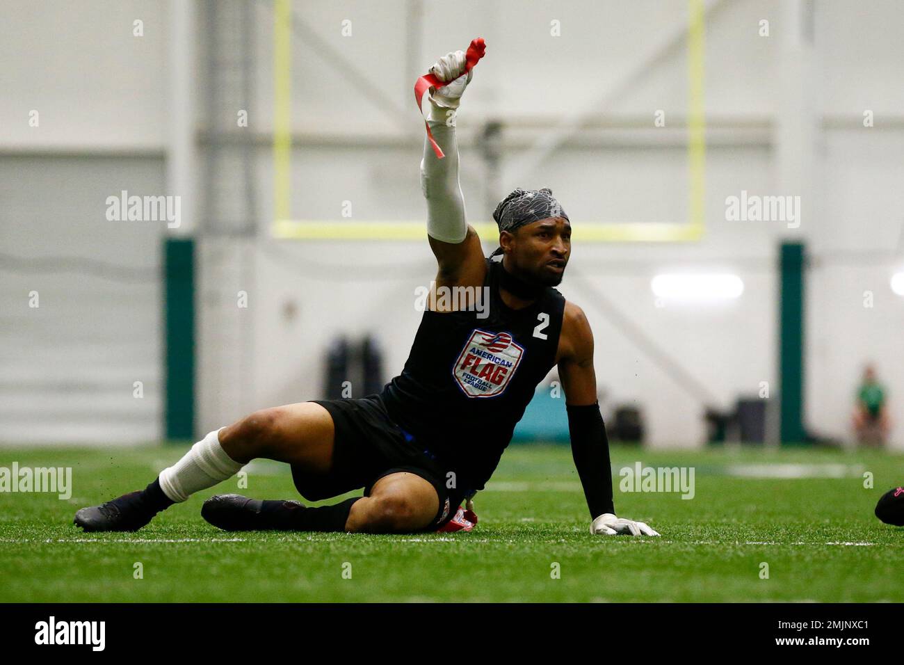 TMT's Anthony "TJ" Webb holds up a flag against TMT during the American ...