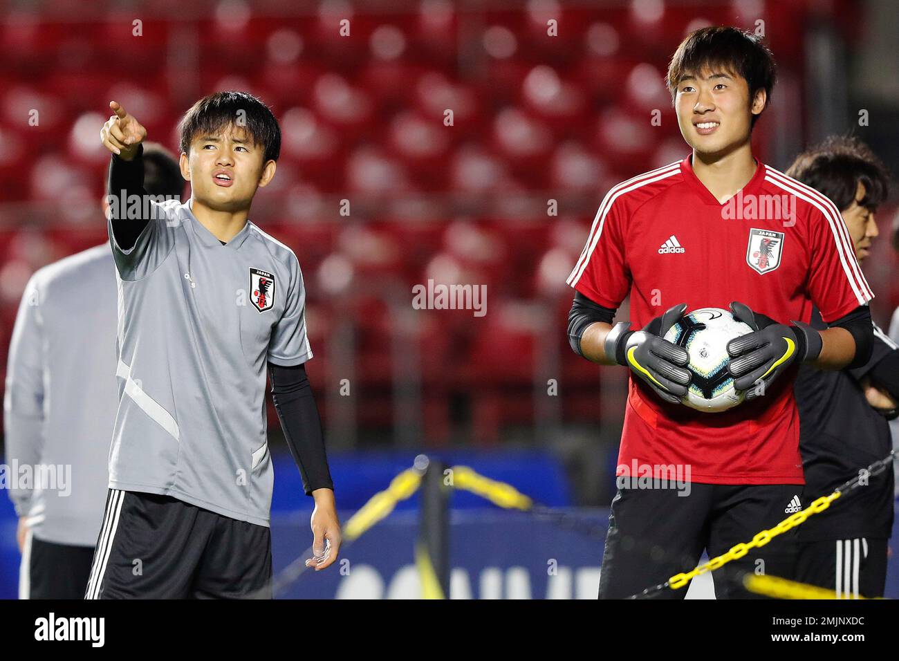 Japan's Takefusa Kubo, left, and goalkeeper Keisuke Osako speaks during ...