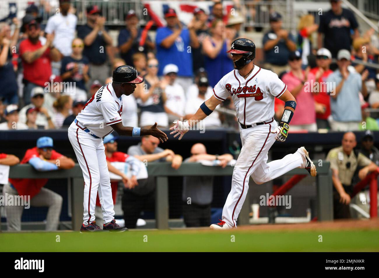 Atlanta Braves' Tyler Flowers, right, is congratulated by third base ...