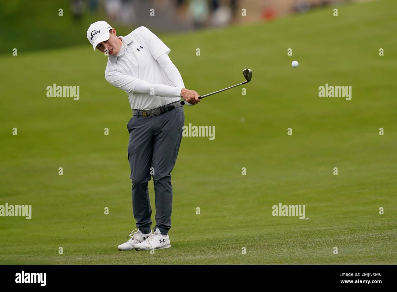 Matthew Fitzpatrick, of England, hits a chip shot on the sixth hole ...