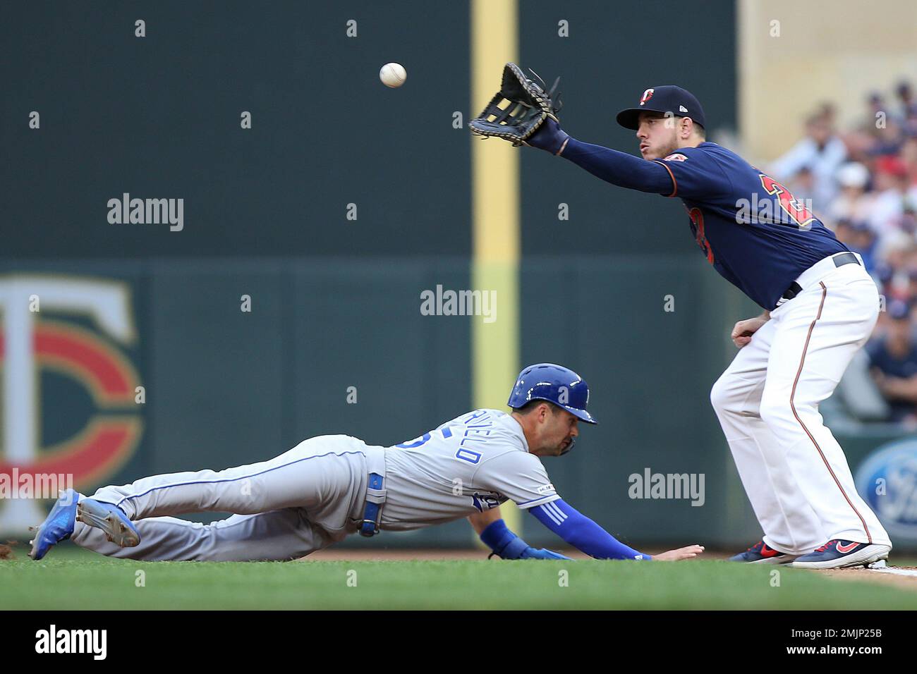 Kansas City Royals' Martin Maldonado, bottom, slides safely back to ...