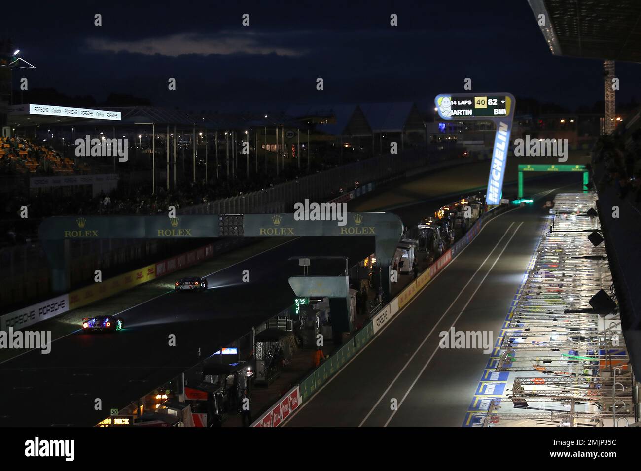 Cars drive past the grandstand at night during the 87th 24-hour Le Mans ...