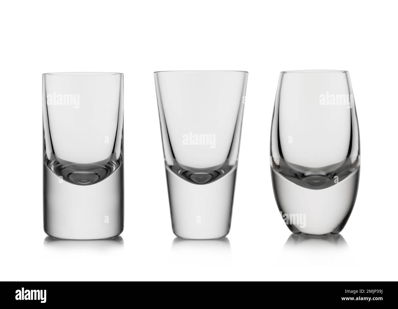 Empty shot glasses with cold vodka alcohol drink on white background ...