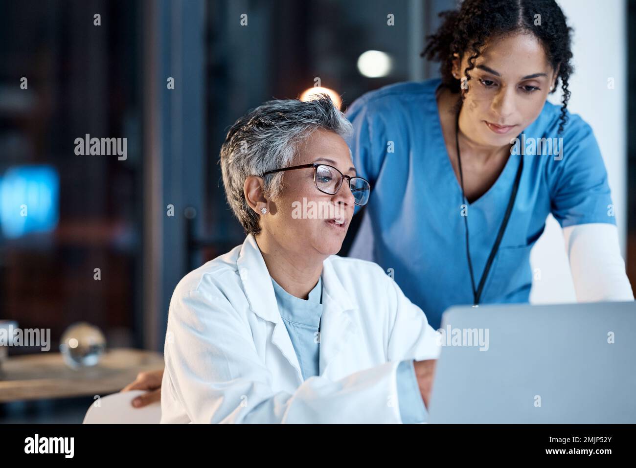 Doctors, nurse or laptop in night teamwork, medical research or surgery planning in wellness ...