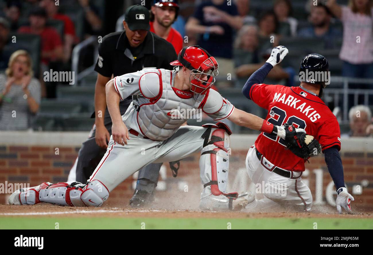 Atlanta Braves' Nick Markakis (22) beats the tag from Philadelphia ...