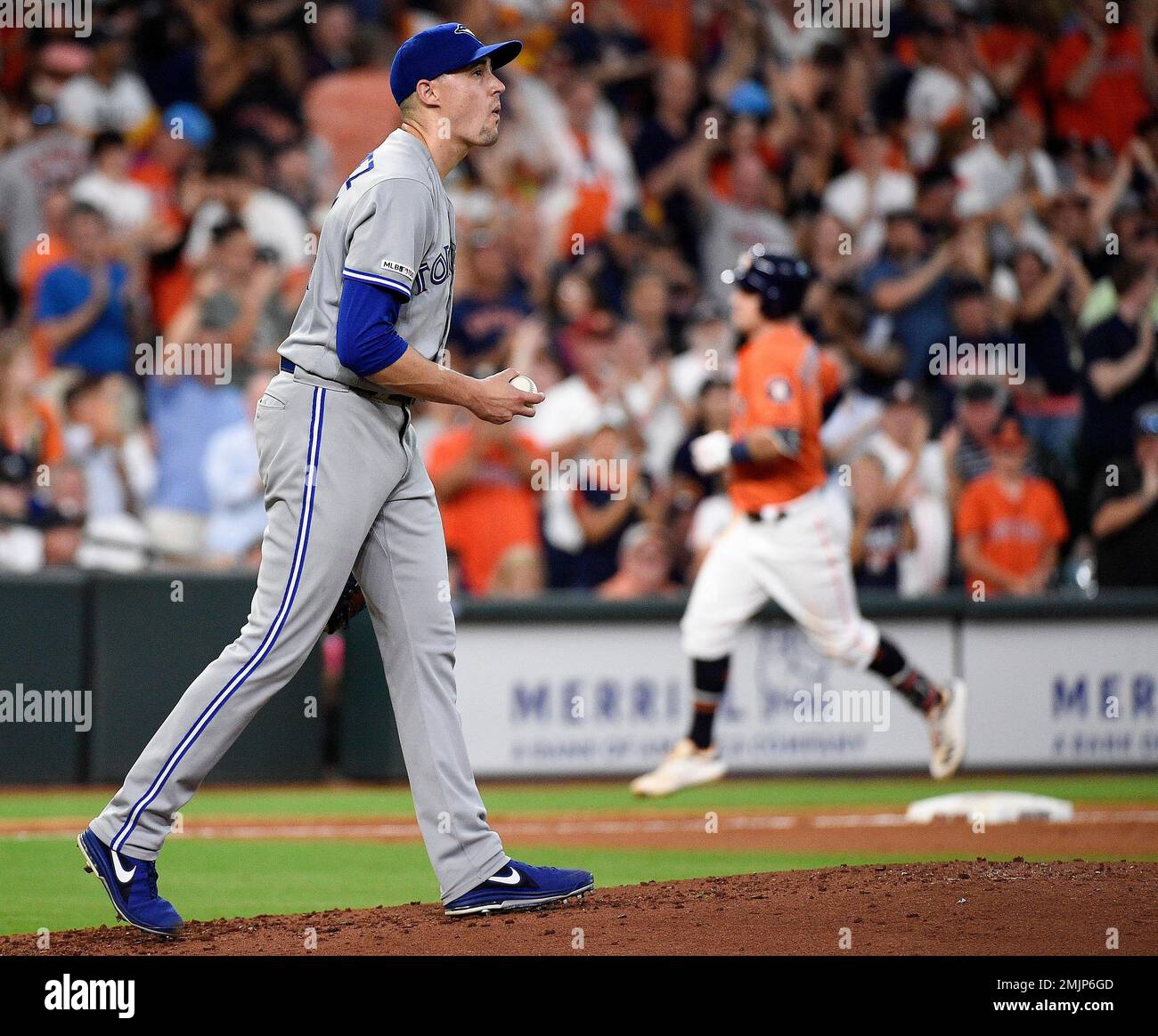 Toronto Blue Jays starting pitcher Aaron Sanchez, left, walks back to ...