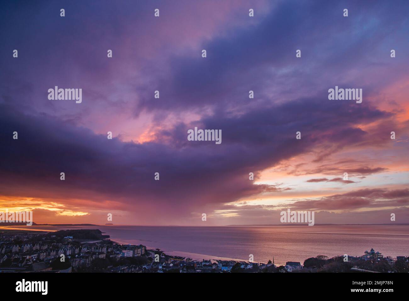 The setting sun lighting up the cloud cover Stock Photo - Alamy