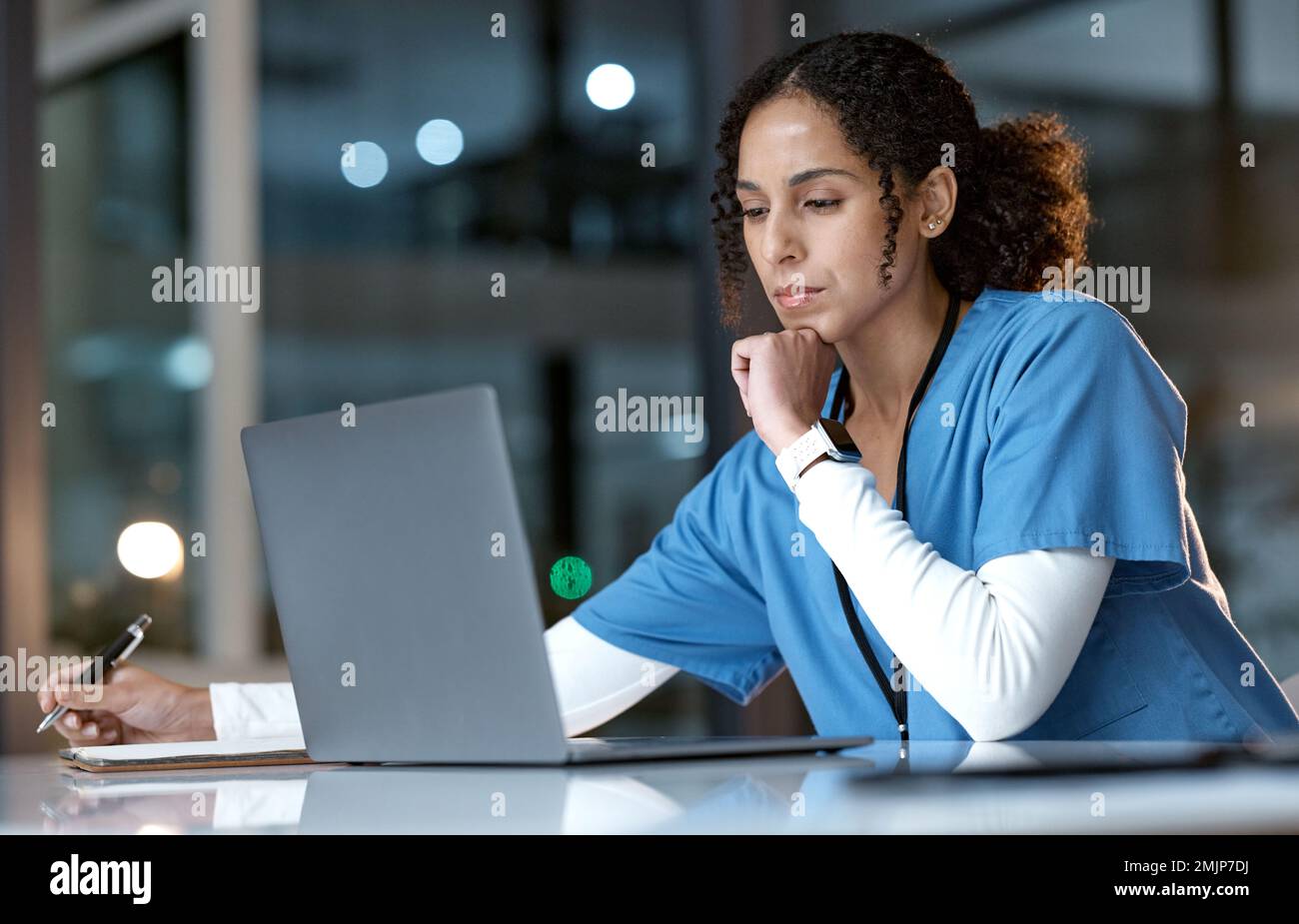 Doctor, thinking and writing with laptop at night for healthcare ...