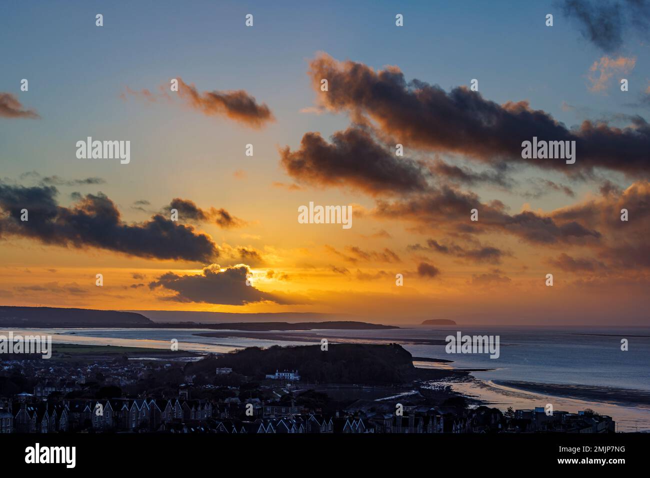 The setting sun lighting up the cloud cover Stock Photo - Alamy