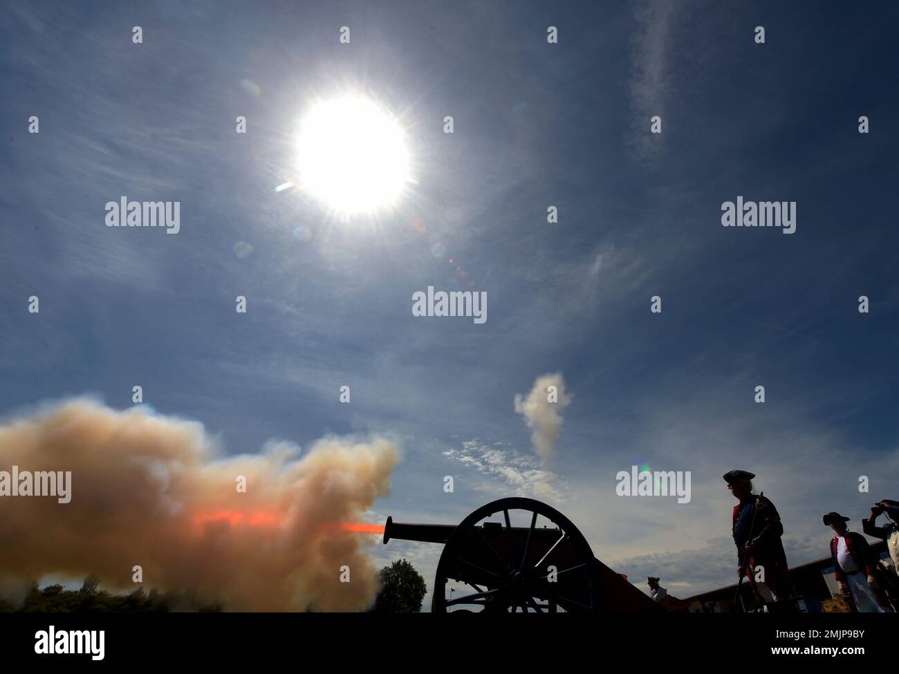 Cannoneer dressed in historical uniforms shoot with their cannon during ...