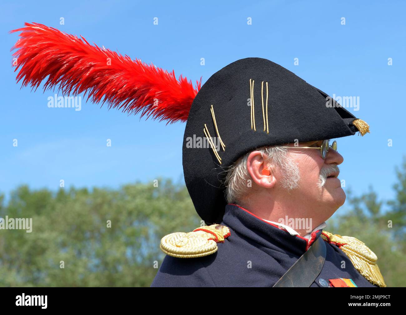 A gunner dressed in a historical uniform waits besides the shooting ...