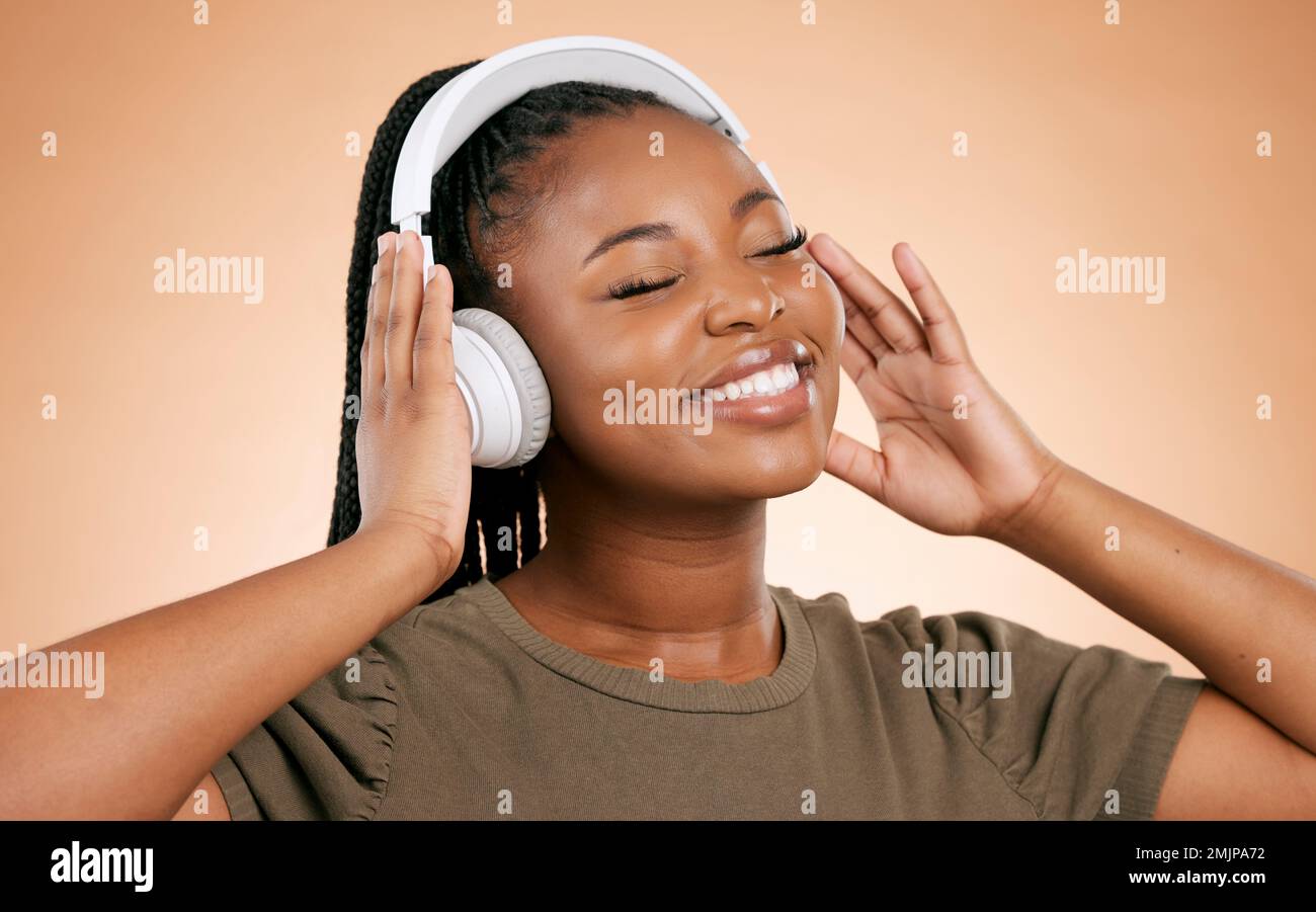 Headphones, music and african woman isolated on studio background for ...