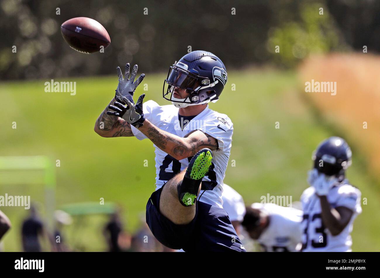 Seattle Seahawks' Jalen Harvey leaps to catch a ball, Thursday, June 13 ...