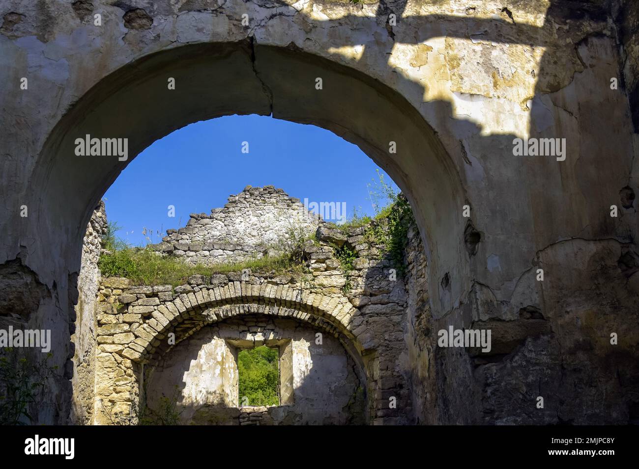Ruins of ancient building against blue sky. Collapsed ceiling. Masonry ...
