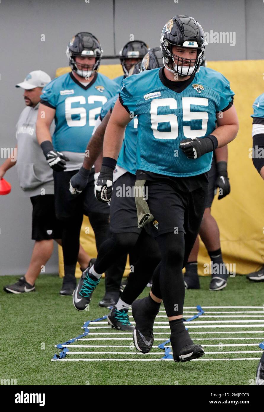 Jacksonville Jaguars center Brandon Linder (65) performs a drill with ...