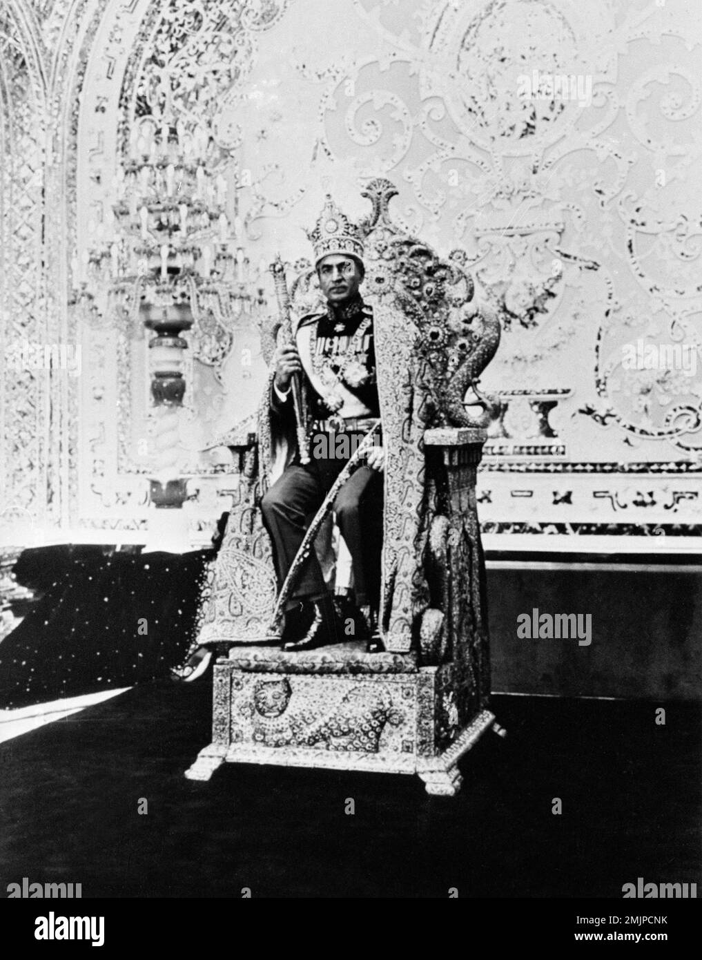 The Shah of Iran, Mohammad Reza Pahlavi, is pictured in full regalia on ...