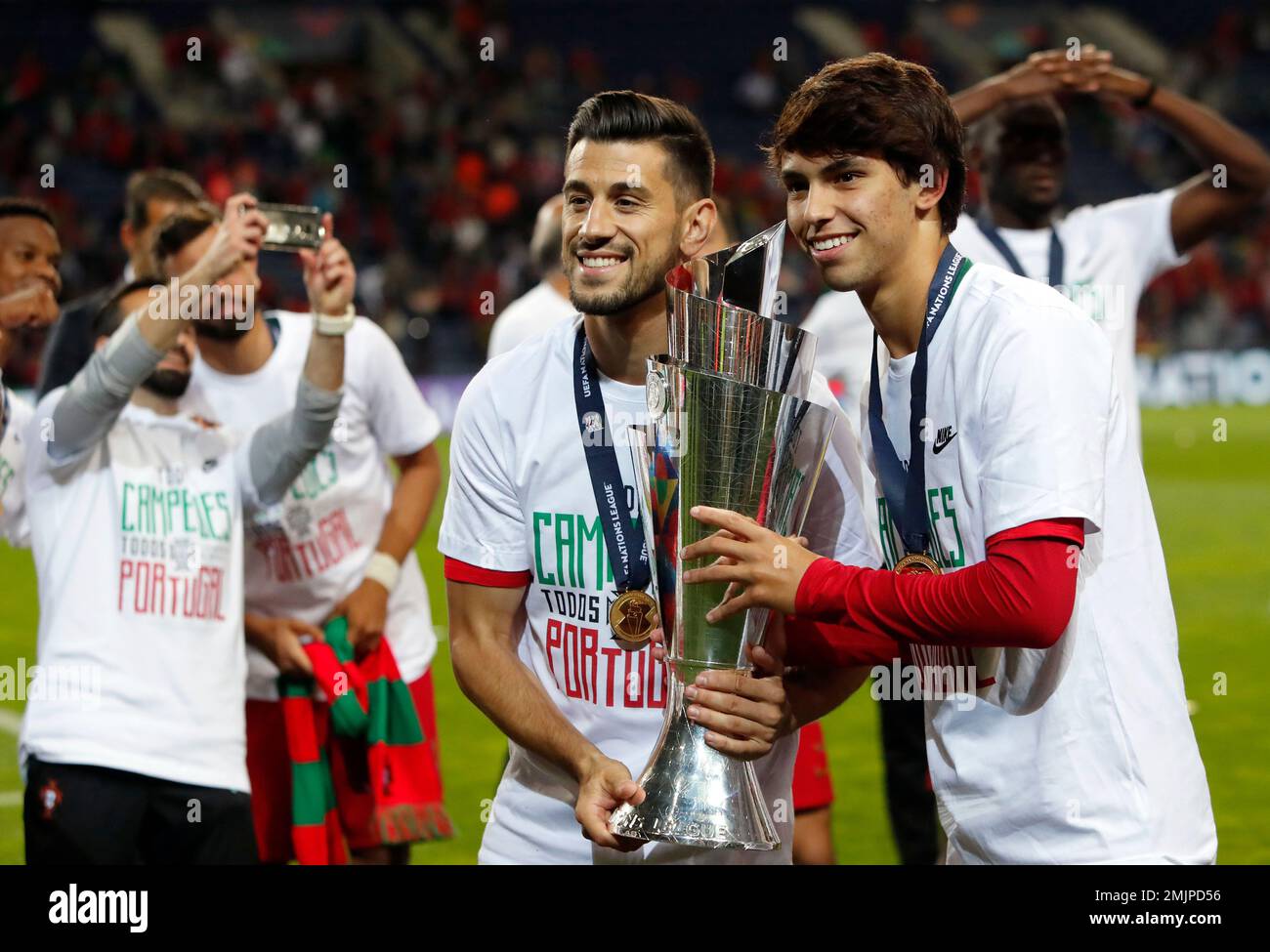 Portugal's Pizzi and Joao Felix, right, pose with the trophy at the end ...