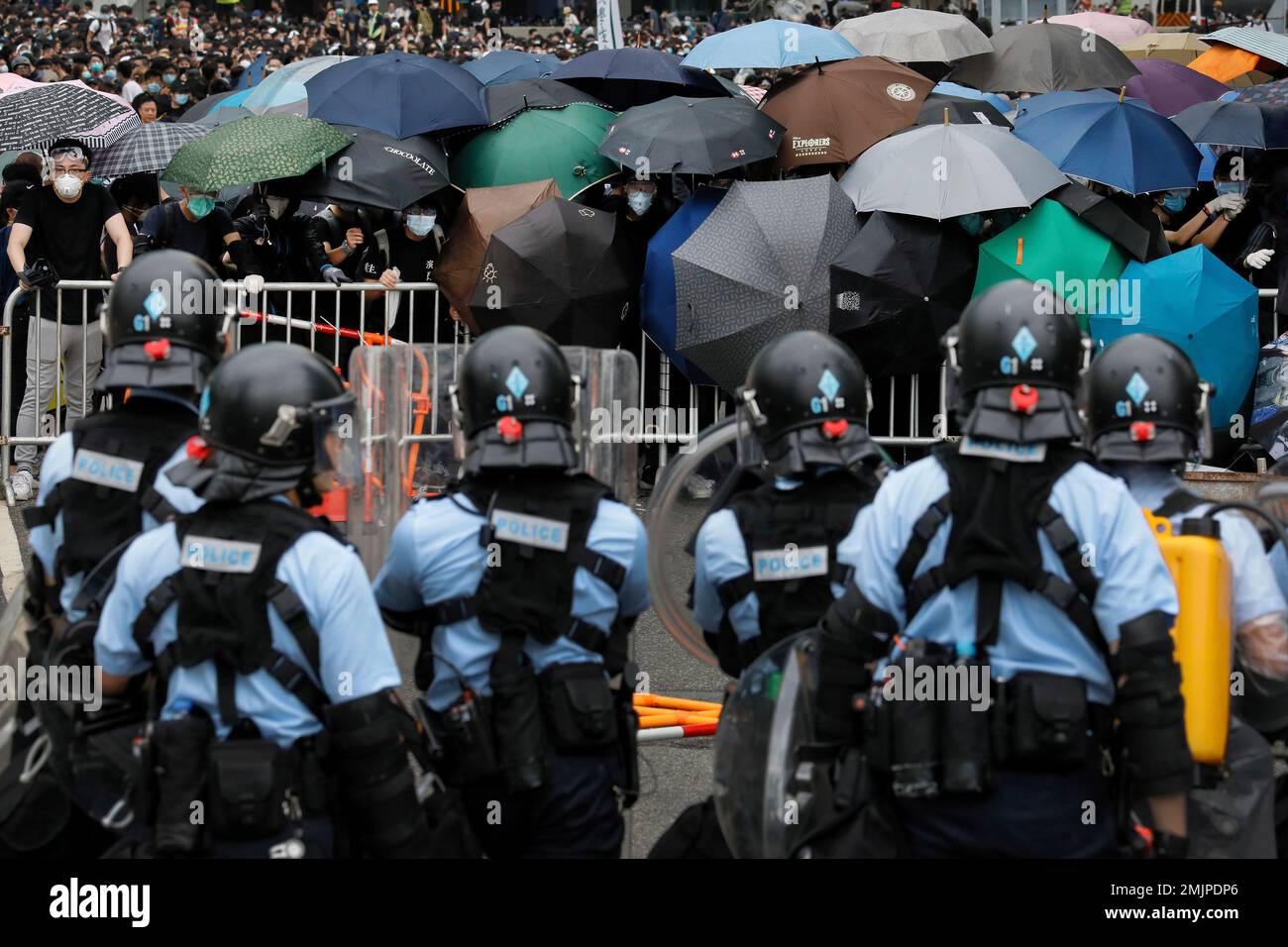 In this June 12, 2019, file photo, policemen line a perimeter as they ...
