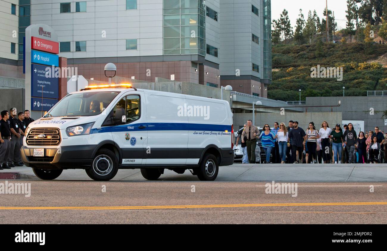 Family, friends, colleagues and others walk in a procession behind a ...