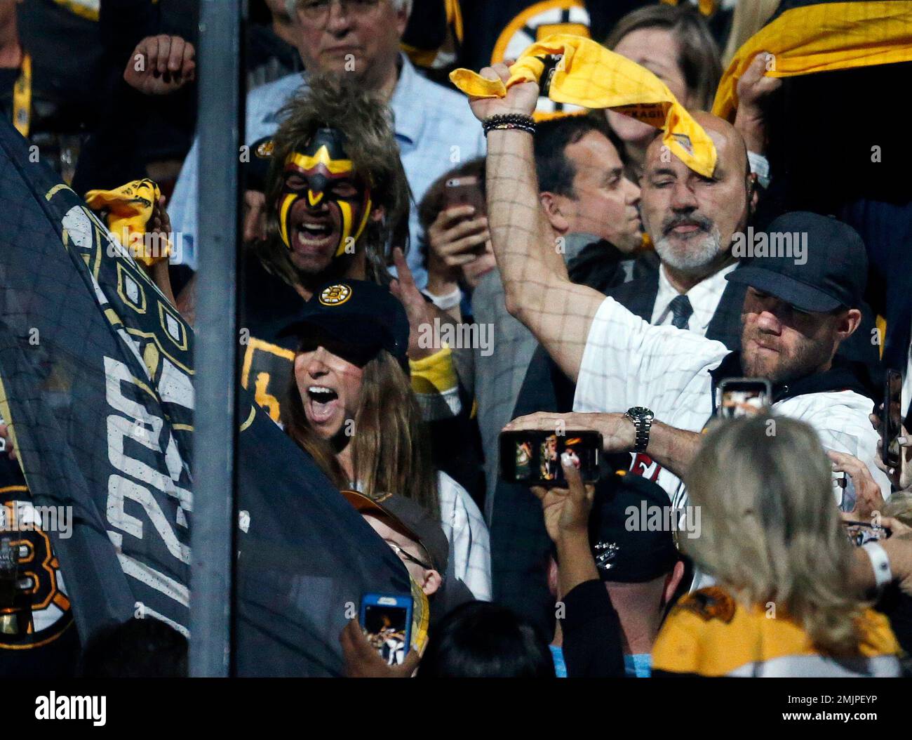 Olympian Ally Raisman, left, waves the Boston Bruins team banner as New ...