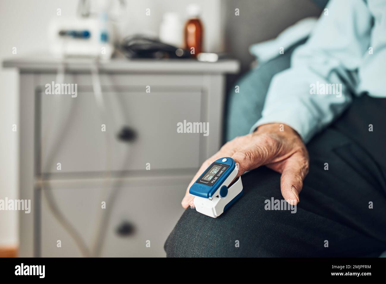Senior man measuring the degree of oxygen saturation of the blood and ...