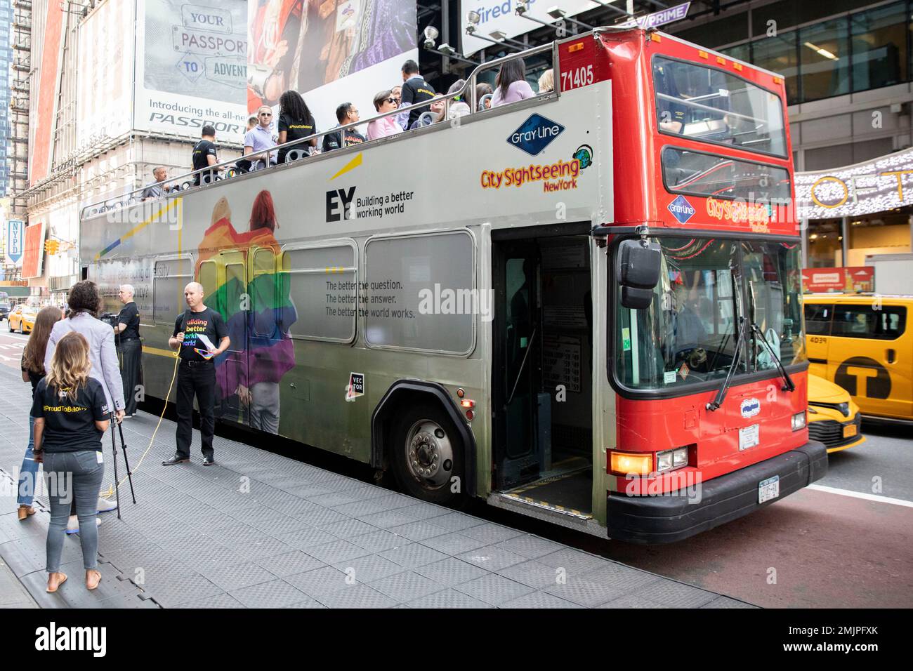 EY Pride bus with EY employee at 5 Times Square on Wednesday, June 12 ...