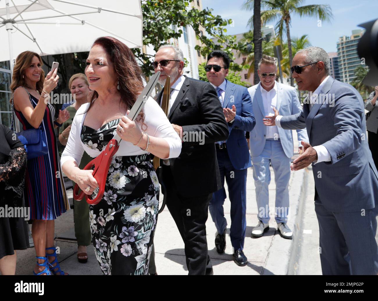 Gloria Estefan, left, and her husband Emilio, second from left, carry ...