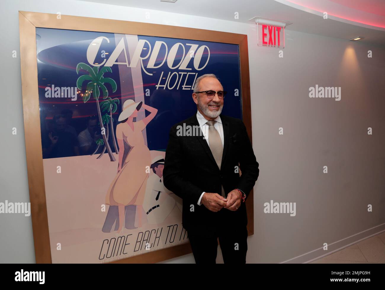 Emilio Estefan poses in front of a poster before a ribbon cutting at ...