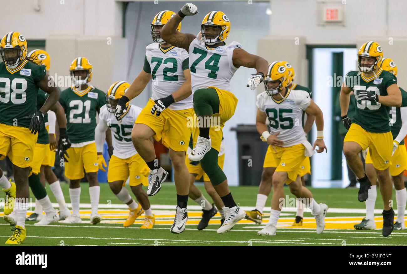 Green Bay Packers Gerhard de Beer (72) and Elton Jenkins (74) jump ... Green Bay Packers Gerhard de Beer (72) and Elton Jenkins (74) jump ...