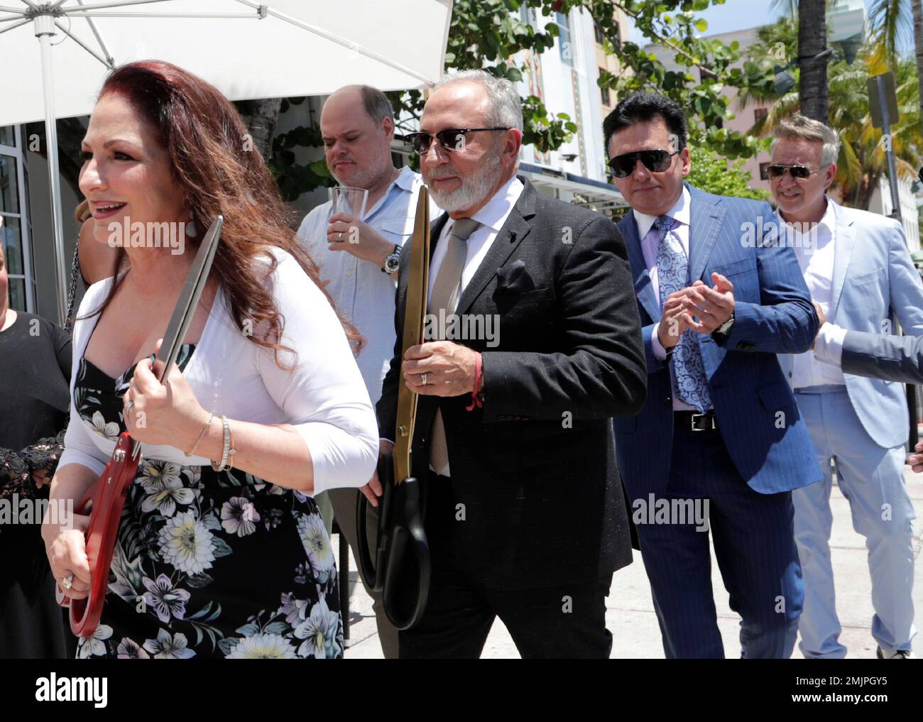 Gloria Estefan, left, and her husband Emilio, second from left, carry ...