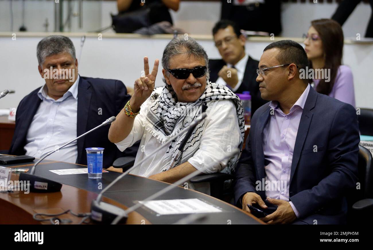 Former FARC rebel Jesus Santrich gives a victory signal to journalists ...