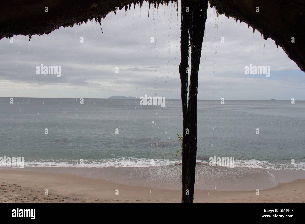 The view from a cave on a horizon line over sea, Homunga Bay, Waikato ...