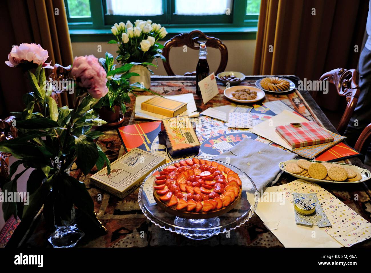 A table is decorated with replicas of gifts Anne Frank received for her ...