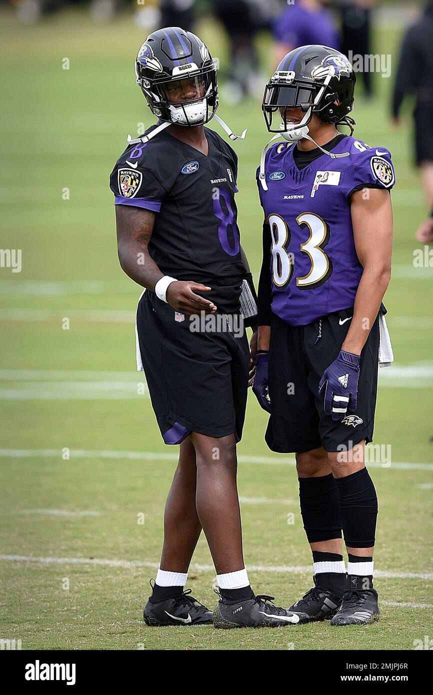 Baltimore Ravens quarterback Lamar Jackson, left, talks with wide ...
