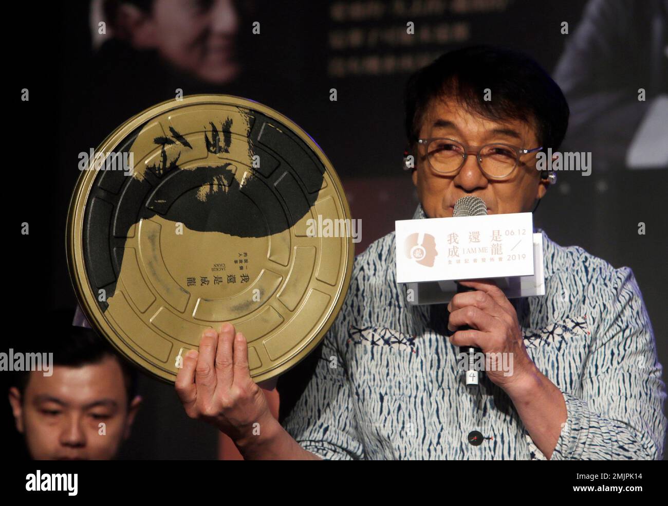 Hong Kong actor and singer Jackie Chan shows his new album during a ...