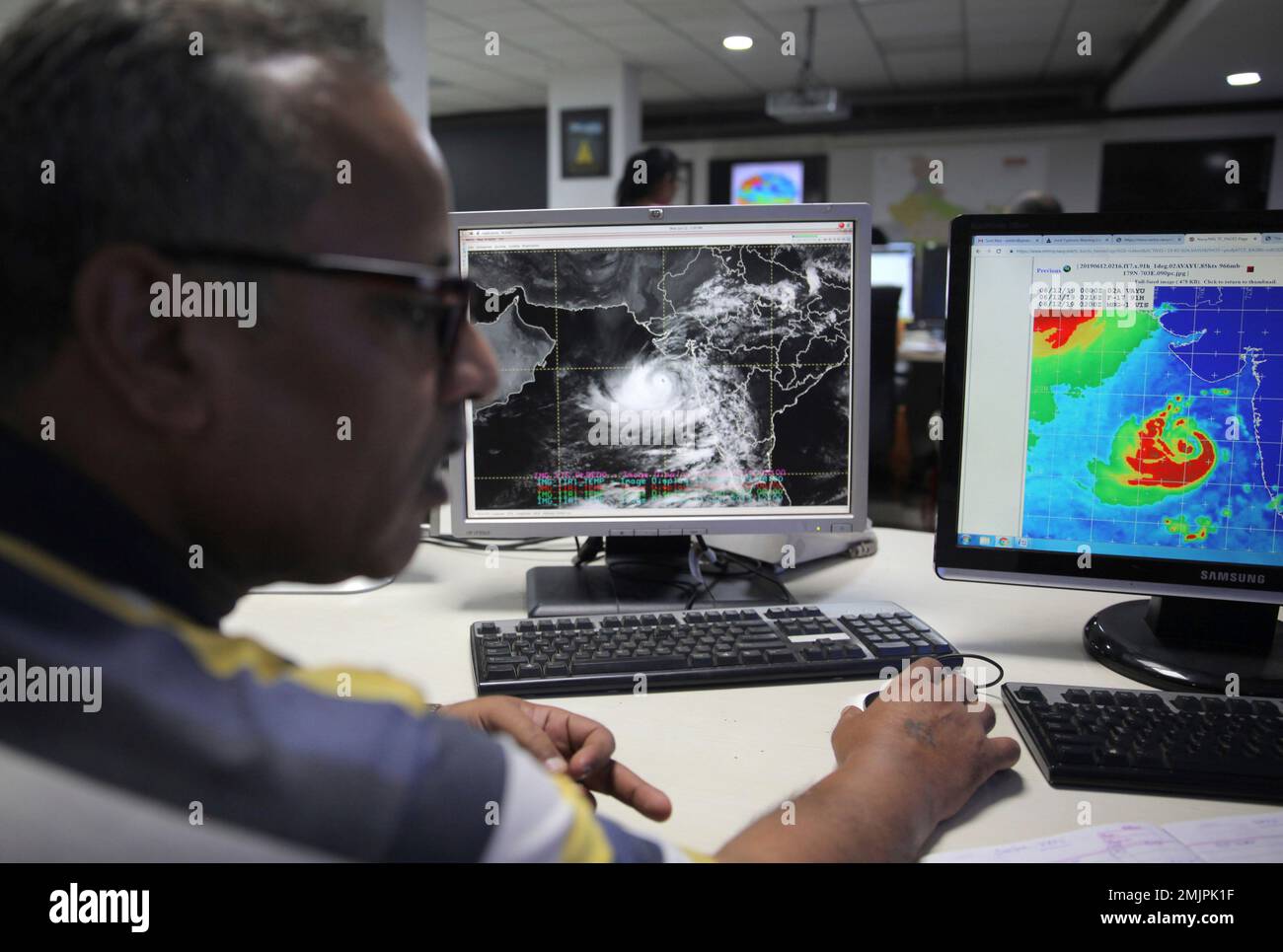 A staffer monitors Cyclone Vayu at a cyclone monitoring center at the ...