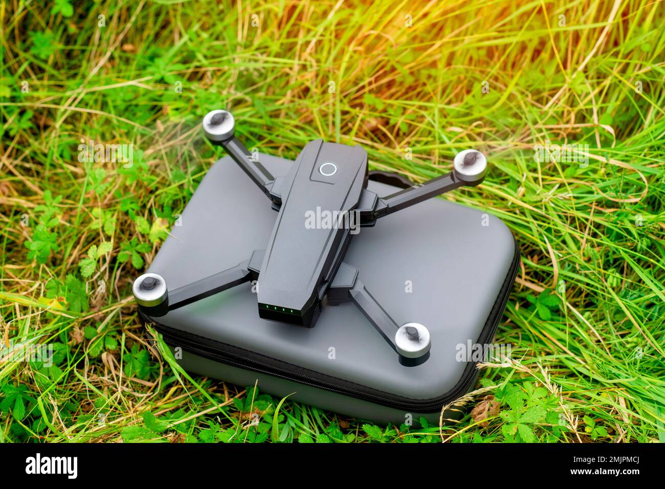 Bearded man using a drone with remote controller making photos and ...