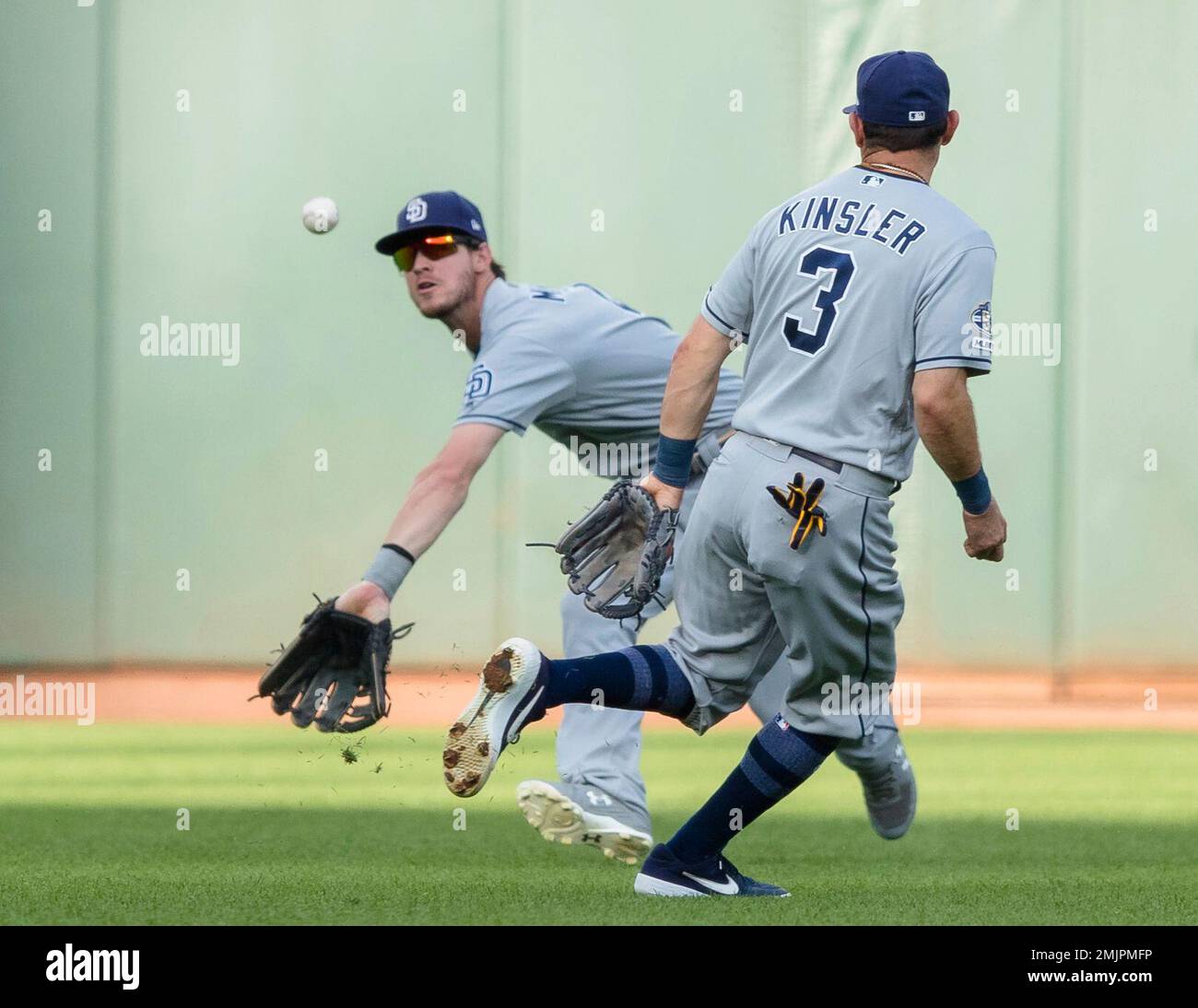 San Diego Padres center fielder Wil Myers, left, fails to catch a fly ...