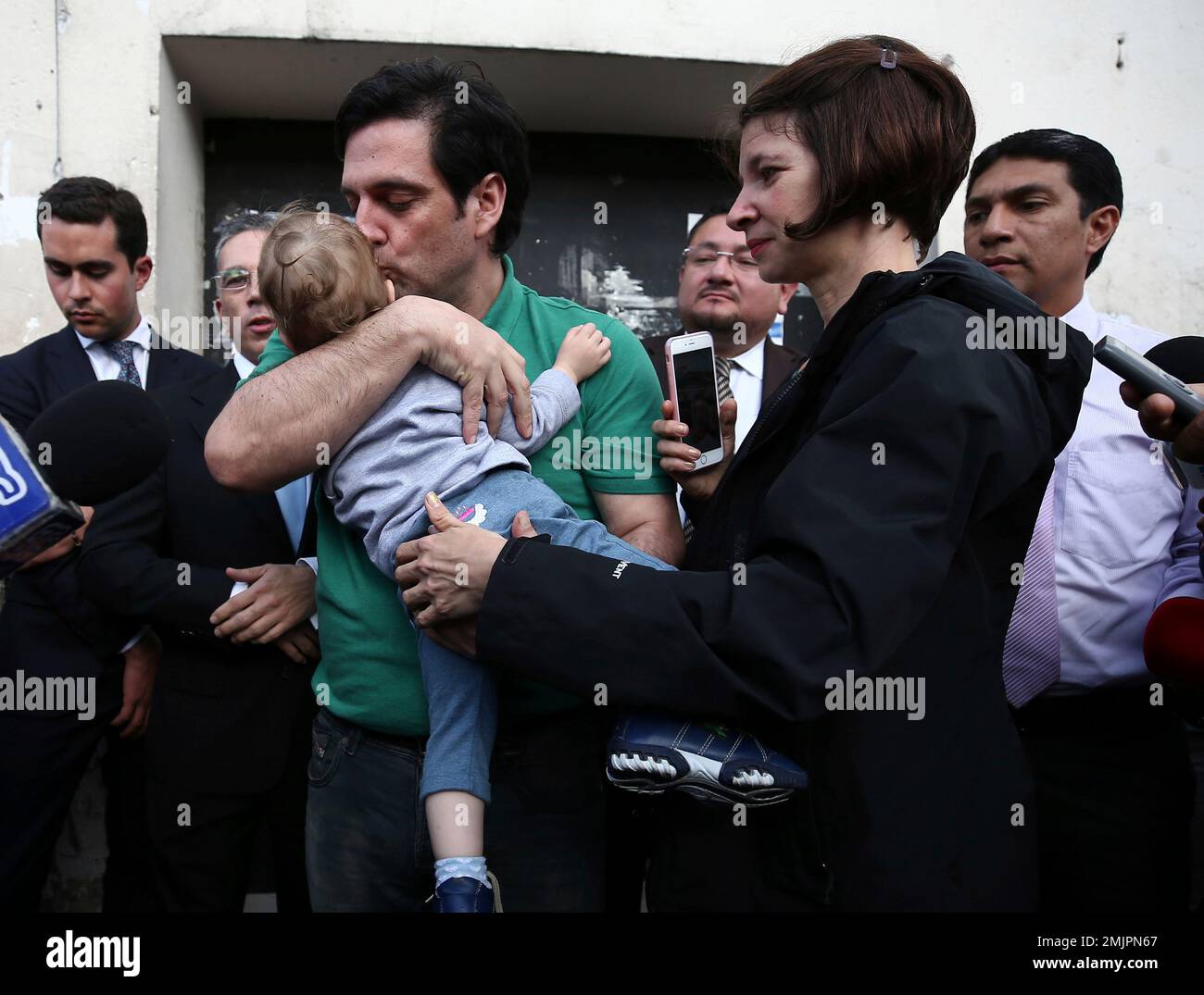 U.S. citizen Paul Ceglia kisses his son Orion held by his wife Marie as ...
