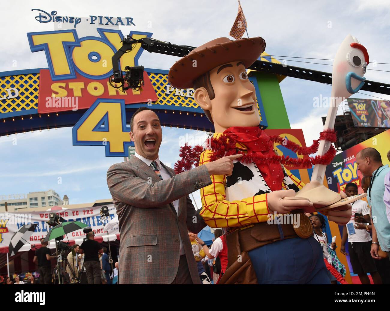 Actor Tony Hale, from left, poses with characters Woody and Forky as he ...